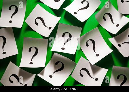 Randomly scattered question marks on white paper Stock Photo - Alamy