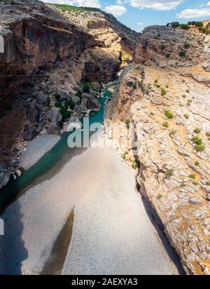 Aerial view of the gorge with prehistoric caves over the the wide and ...