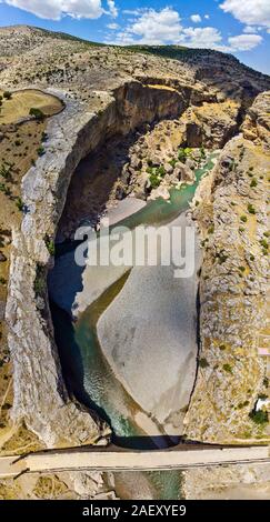 Aerial view of the gorge with prehistoric caves over the the wide and ...