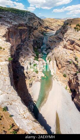 Aerial view of the gorge with prehistoric caves over the the wide and ...