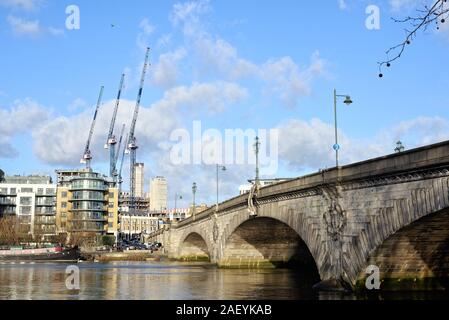 Kew Bridge across the River Thames, pictured at low tide on a cloudy ...