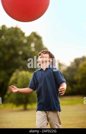 Kids Red Bouncy Ball In Yellow Bucket Stock Photo - Alamy
