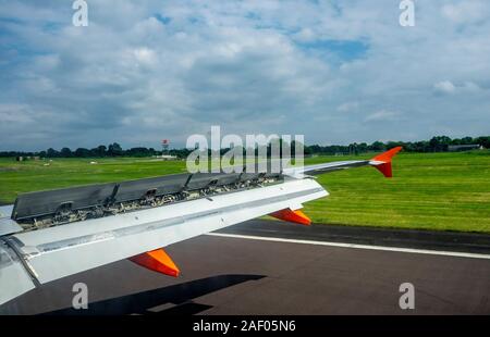 Wing brake flaps open on a Ryanair Boeing 737 - 800 landing in the rain ...