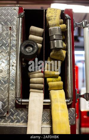 Folded fire hose on back of fire engine Stock Photo - Alamy