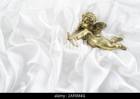 cupidon with arrow on cream,white background Stock Photo - Alamy