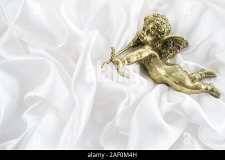 cupidon with arrow on cream,white background Stock Photo - Alamy