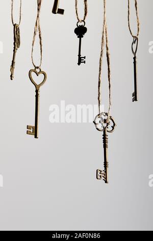 vintage keys hanging on ropes isolated on white Stock Photo - Alamy