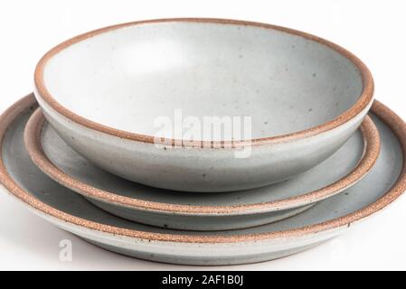 Different plates with bowls on white grunge background Stock Photo - Alamy