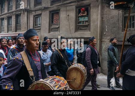 Men Newari in traditional dress at the bell of Mahendreshwar Temple ...