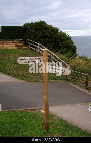 A wooden signpost showing the Cleveland way and Robin hoods bay located ...