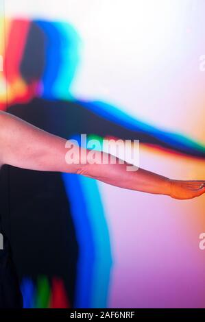 Art project. Color lights are projected onto a reflective screen the ...