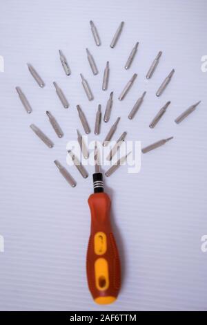 Yellow and red hand screwdrivers and screws isolated Stock Photo - Alamy