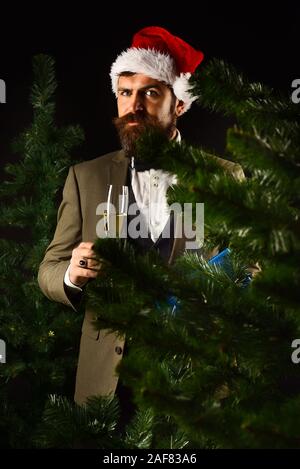 Businessman with serious face holds bald Christmas tree up Stock Photo ...