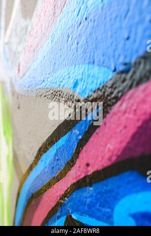 Detail of an anonymous street graffiti with many colors, cheerful urban ...