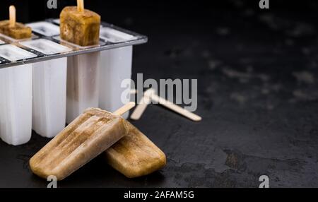 Some homemade Cola Popsicles (close-up shot; selective focus) on ...