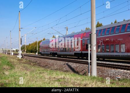 Double-decker high-speed passenger train at the station Stock Photo - Alamy