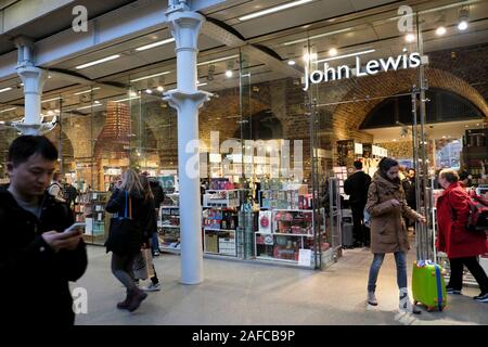 People with luggage and shoppers outside John Lewis store shops at St ...
