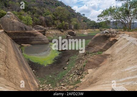 Matobo national Park, zimbabwe. A boat on the ground of an empty lake ...