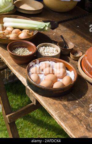 Table with a selection of typical medieval food including boiled ham ...