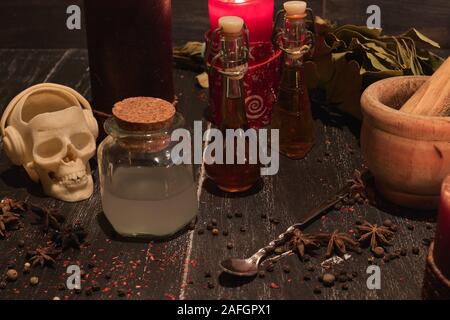 Potion of natural herbs for black magic, with mortar, skulls and ...