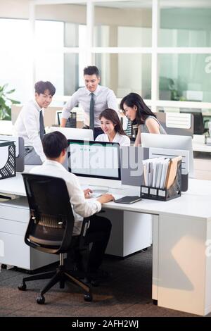 Chinese business people using computer in office Stock Photo - Alamy
