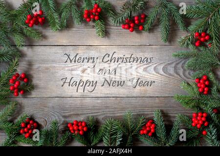 Christmas fir tree branches with rowan on wooden table Stock Photo - Alamy