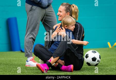Victoria Azarenka of Belarus warms up for her doubles match with son ...