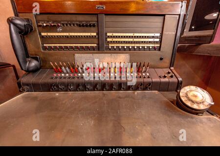 Old analog telephone switchboard system connection panel with wire ...