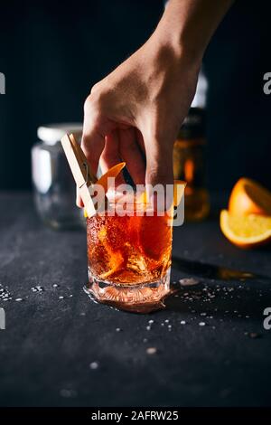 Alcoholic cocktail with orange peel and ice Stock Photo - Alamy