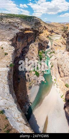 Aerial view of the gorge with prehistoric caves over the the wide and ...