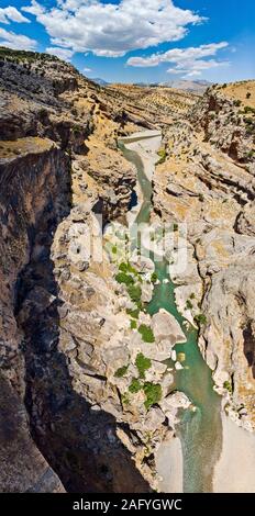 Aerial view of the gorge with prehistoric caves over the the wide and ...