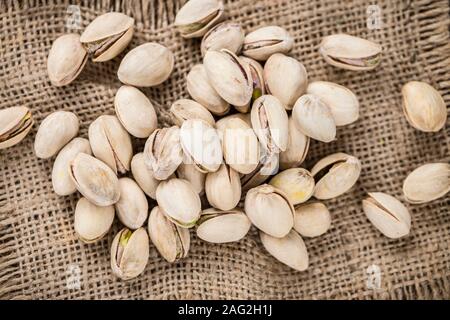 Closeup shot of fresh pistachios on a wooden table in a basket Stock ...