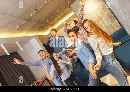 Diverse and multicultural friends dancing on the beach during a summer ...