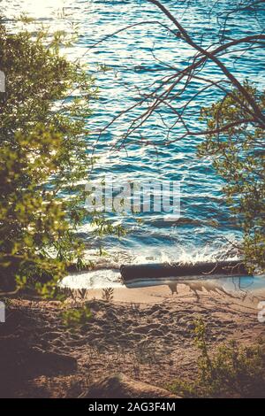 A vertical shot of sun rays reflected on a lake Stock Photo - Alamy