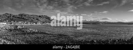 Greyscale shot of the rocks and calm sea during sunset Stock Photo - Alamy