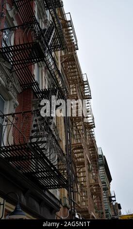 Building facades with fire escapes in China Town, New York City, USA ...