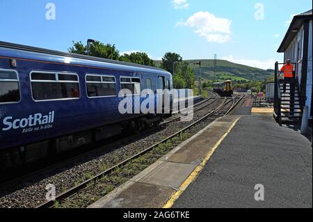 A signalman and train driver exchanging the single line working token ...