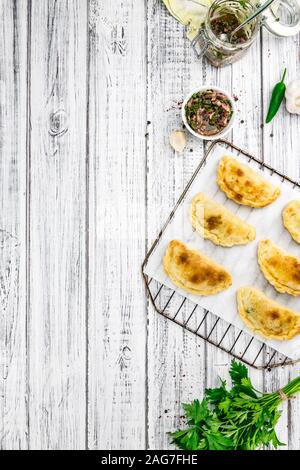 A selective focus shot of a delicious meat croissant and a tea cup in a ...