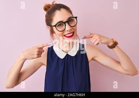 Redhead woman with pigtail wearing elegant dress and glasses over ...