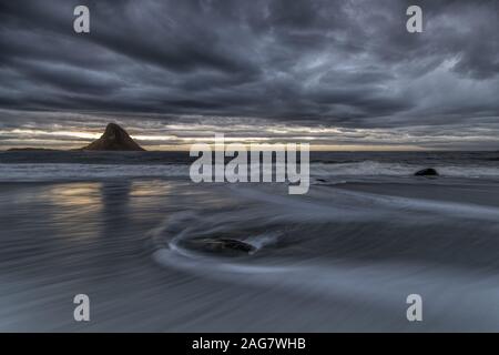 Beautiful shot of a strong water vortex under the gloomy sky in Lofoten ...