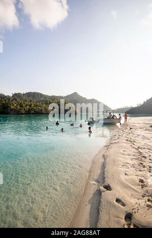 guest swimmers in shallow inlet water tropical island Raja Ampat ...