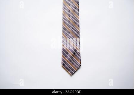 Overhead shot of a striped tie on a white surface Stock Photo - Alamy