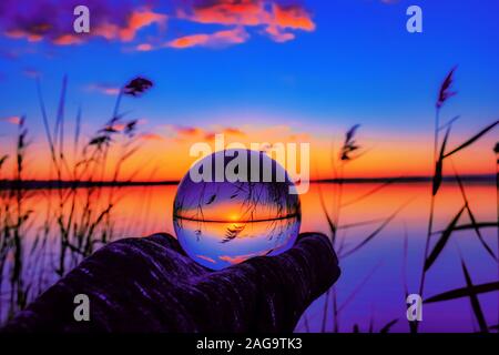 Beautiful shot of the sunset with a reflecting crystal ball up front ...