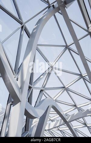 Vertical low angle shot of a geometrical buildings under the clear blue ...