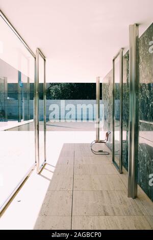 Vertical shot of a hallway with white walls and old chandeliers on the ...