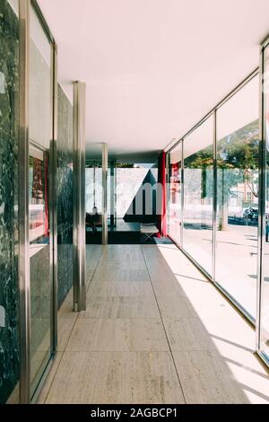 Vertical shot of a hallway with white walls and old chandeliers on the ...