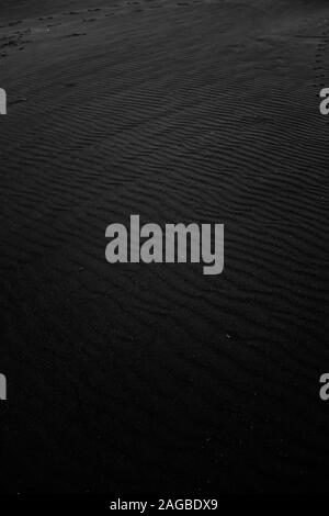 A vertical shot of the grey sand texture at the beach Stock Photo - Alamy
