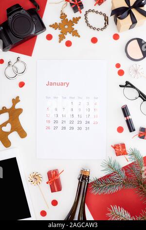 Tablet with calendar, champagne and Christmas decor. Xmas device screen ...