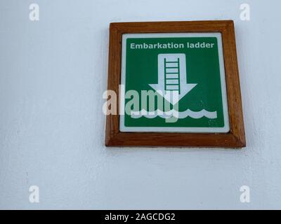 White life raft and embarkation ladder on deck of container ship ready ...