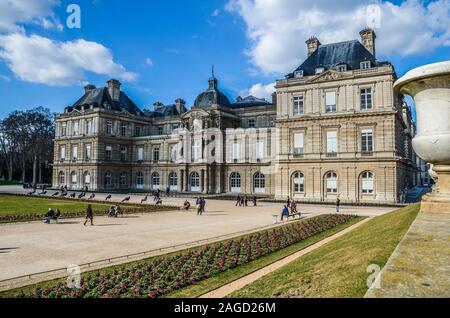 The Luxembourg Garden and the Palace of Luxembourg surrounded by people ...